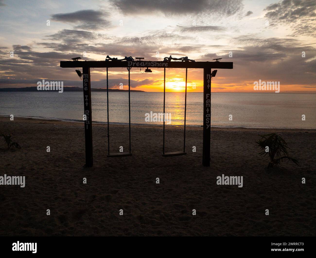 Swing on sandy beach with ocean waves and sunset background. Santa Fe ...