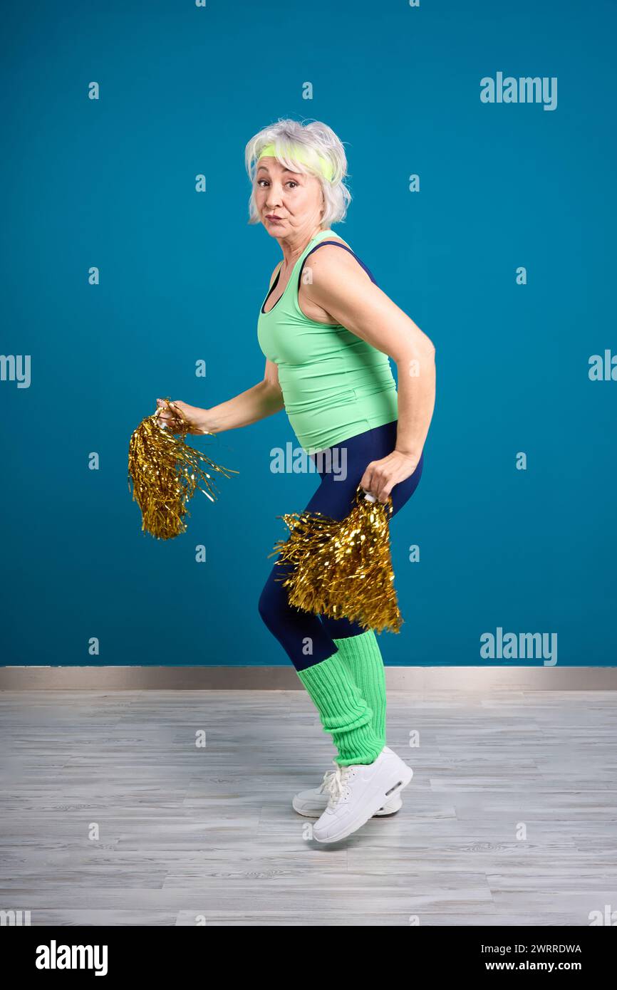 Active senior lady with cheerleading Pom-Poms Stock Photo - Alamy