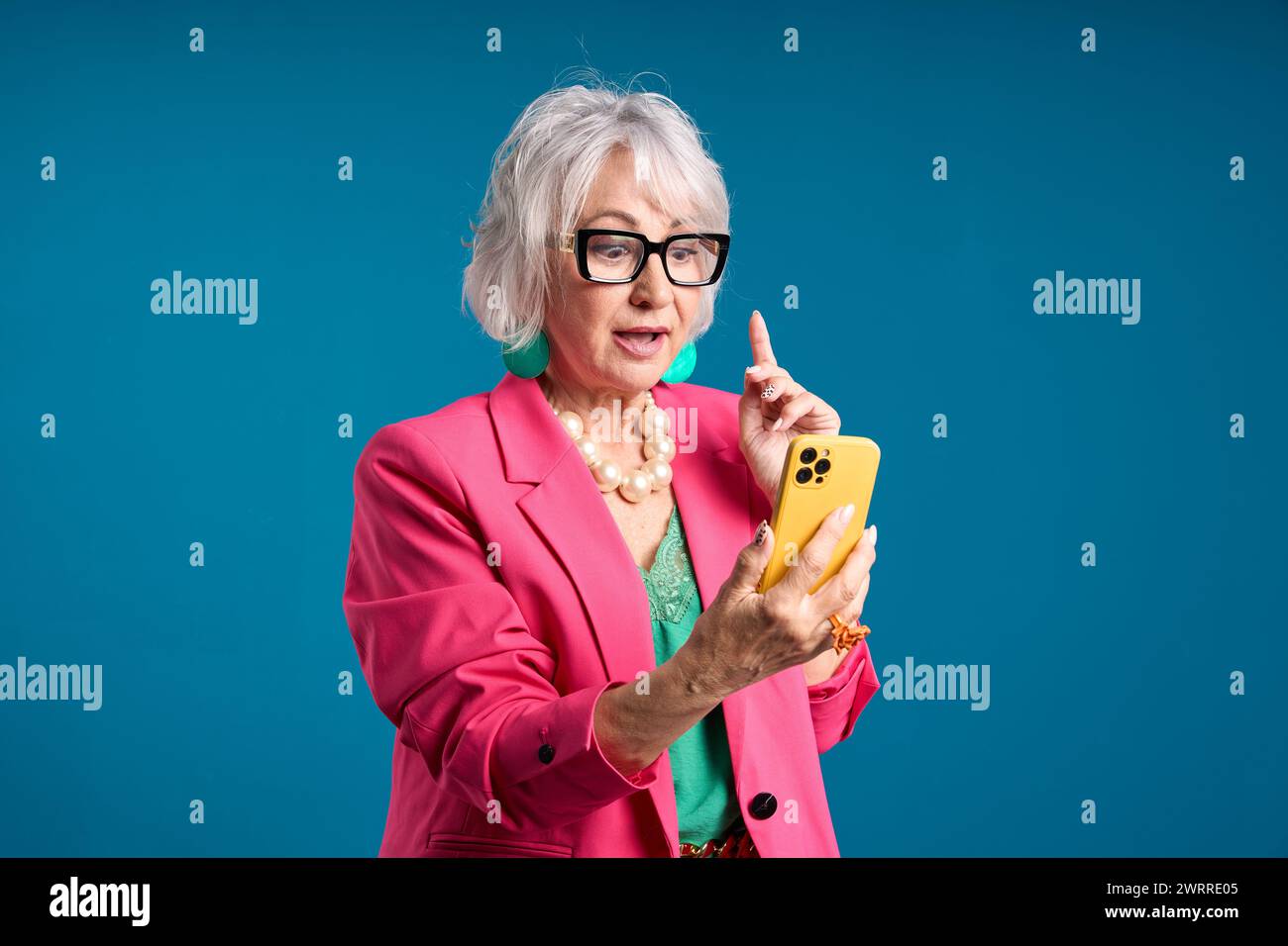 Senior Woman with Smartphone Having an Aha Moment Stock Photo - Alamy