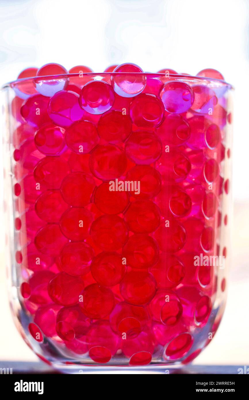glass jar full of hydrogel red spheres, white background Stock Photo ...