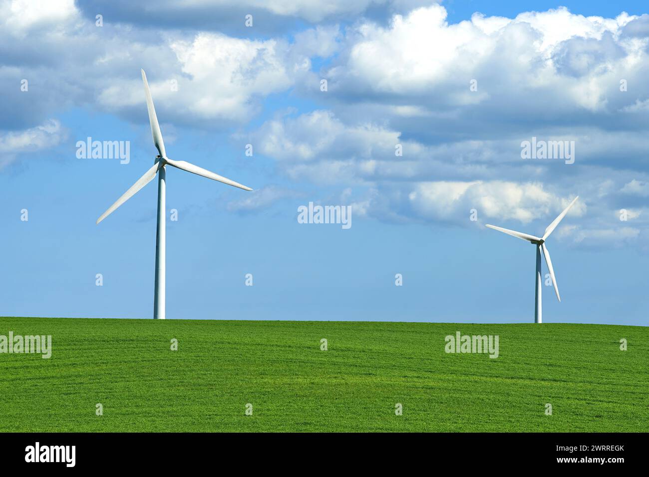 Wind turbine, grass and sky with clouds for nature in environment and ...