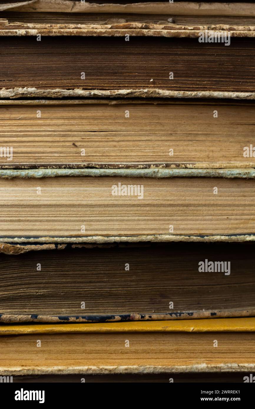 Book background. Stack of books in the library. Old yellow pages of ...