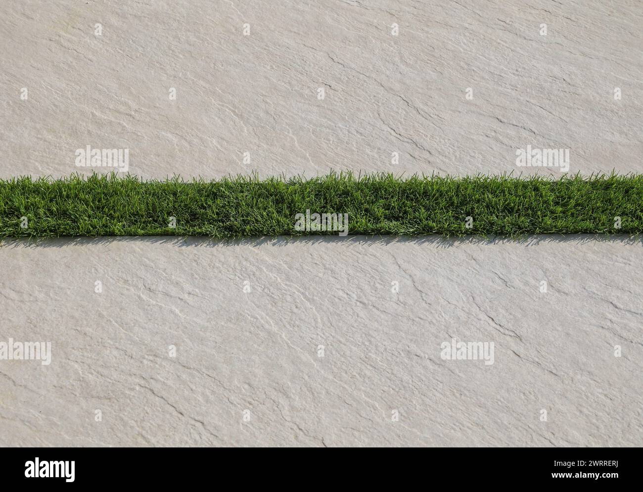 strip of green synthetic grass like real between two stone tiles Stock ...