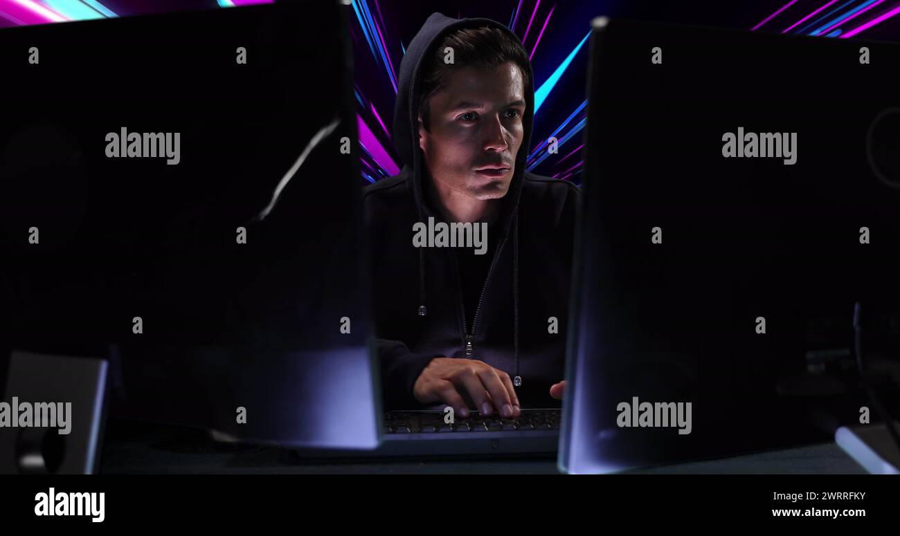 Image of caucasian male hacker over pink and blue neon light trails ...