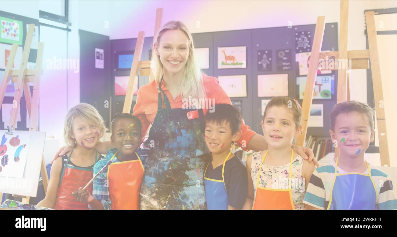 Image of smiling caucasian female teacher painting with diverse ...