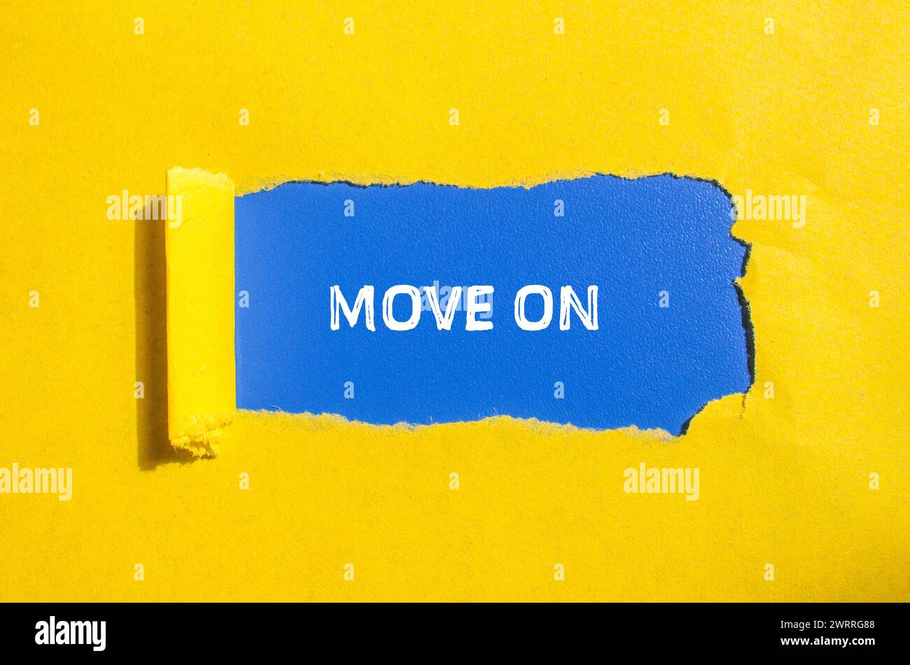 Move on words written on yellow torn paper with blue background. Conceptual symbol. Copy space ...