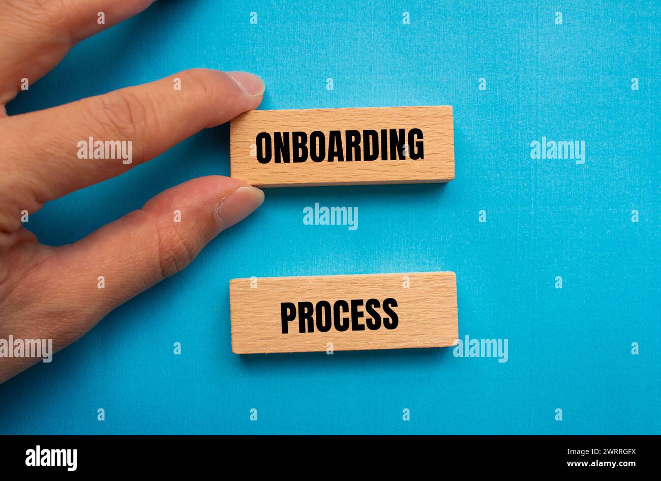 Onboarding process words written on wooden blocks with blue background ...