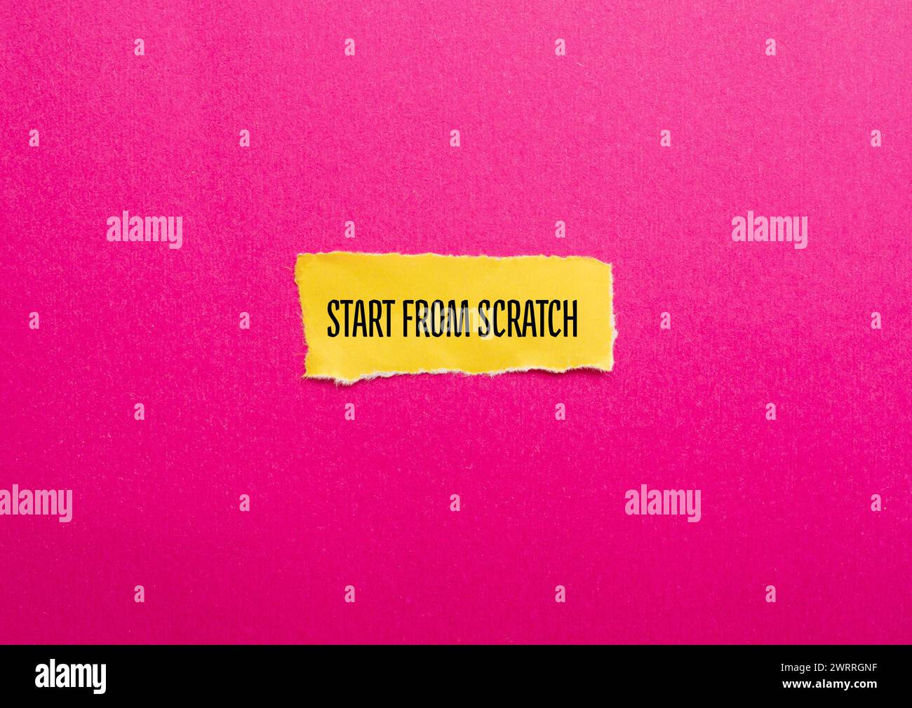 Start from scratch words written on yellow torn paper with pink ...