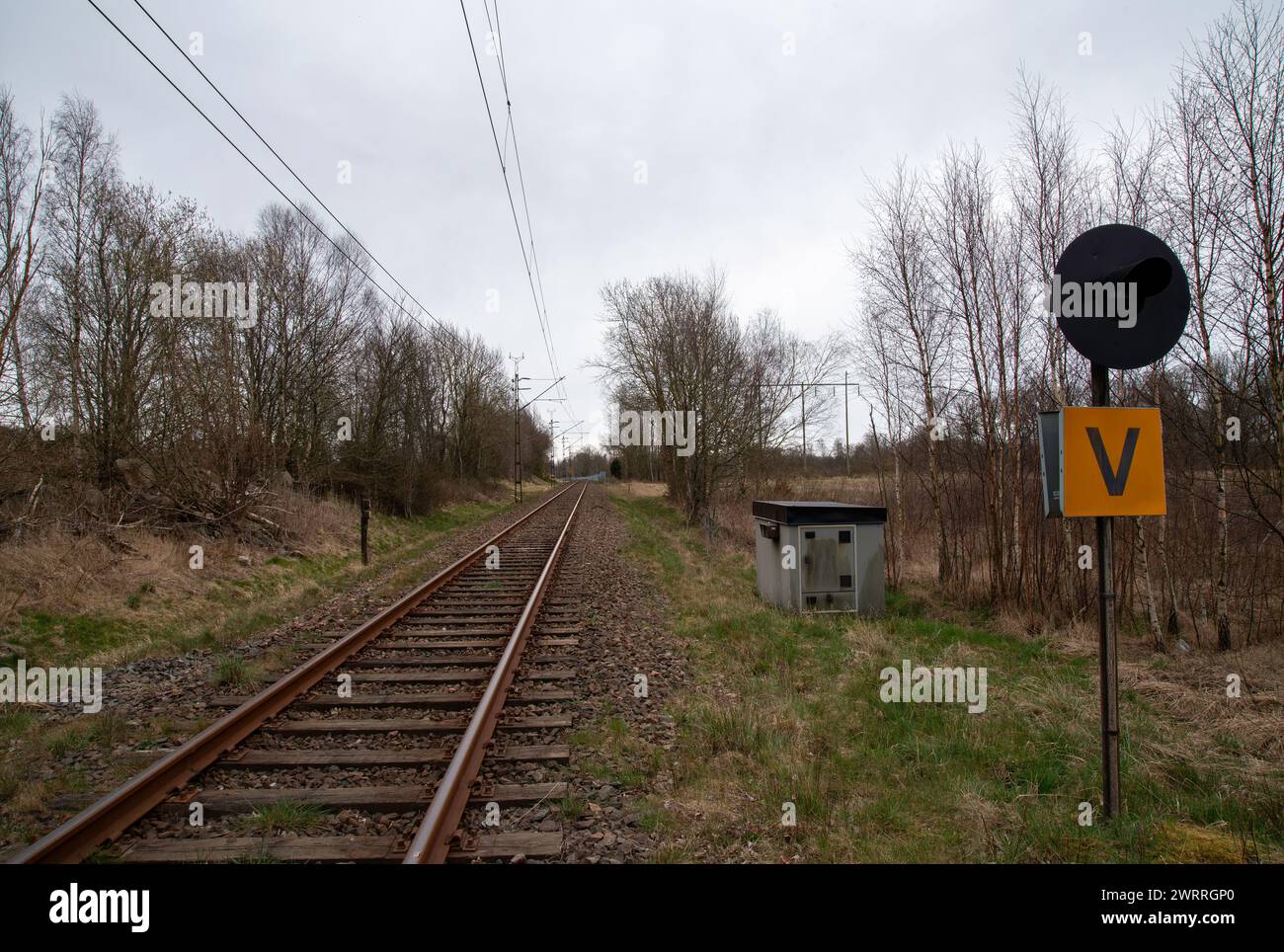 Straigh rail line with signal and sign Stock Photo - Alamy