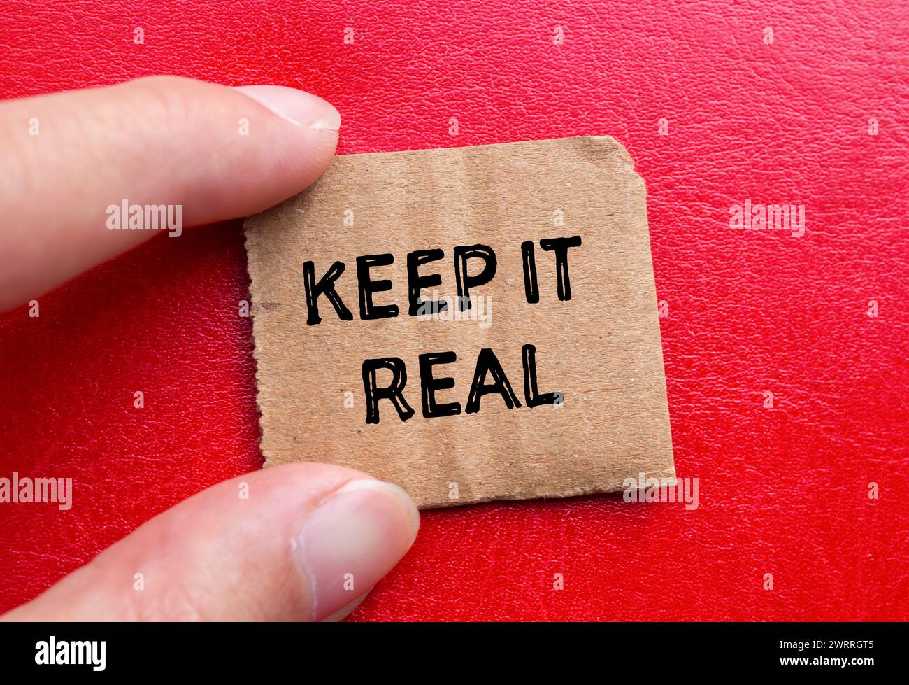 Keep it real words written on torn paper piece with red background ...