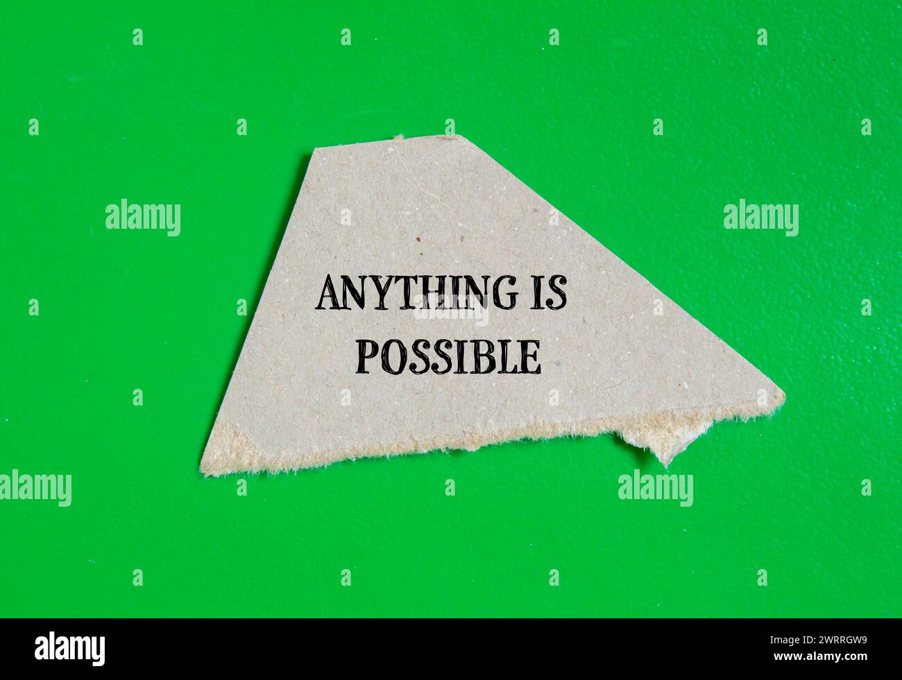 Anything is possible words written on torn paper piece with green ...