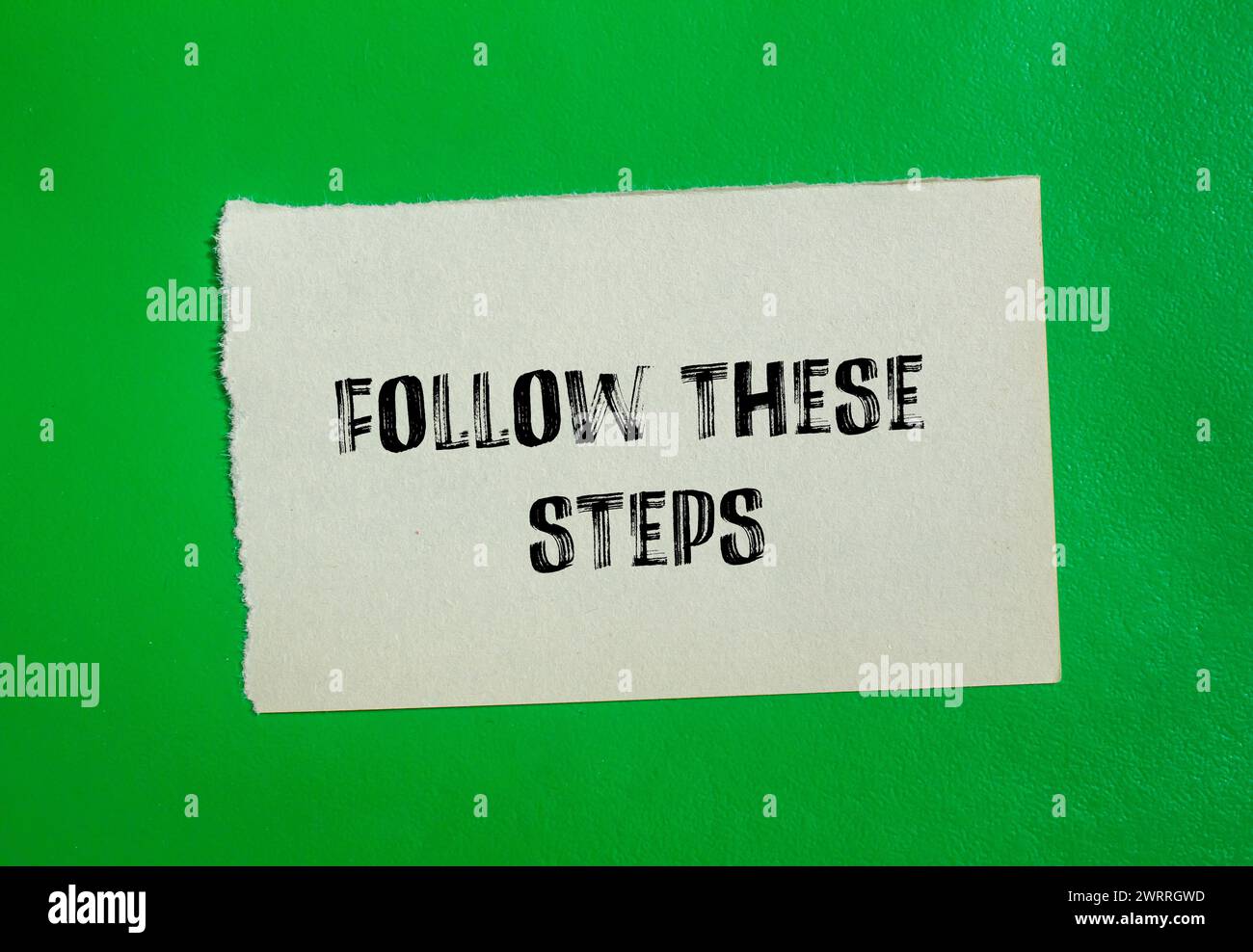Follow these steps words written on torn paper piece with green ...