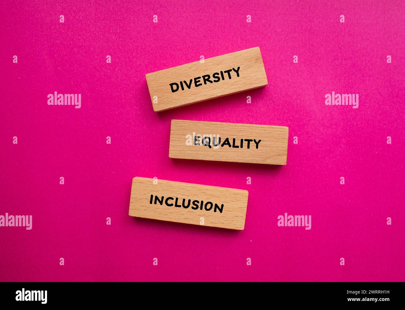 Diversity, equality, inclusion words written on wooden blocks with pink ...