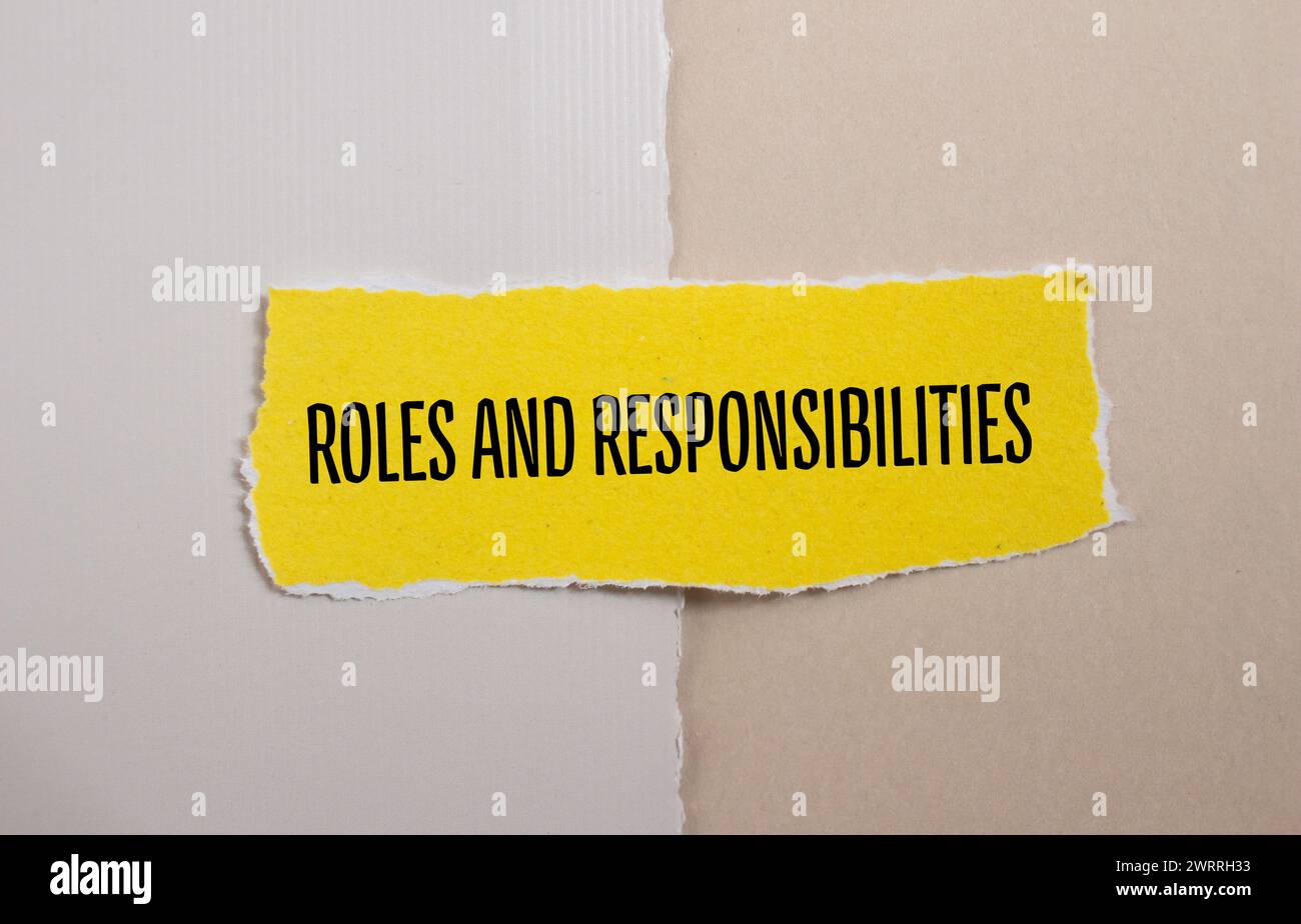 Roles and responsibilities words written on yellow torn paper ...