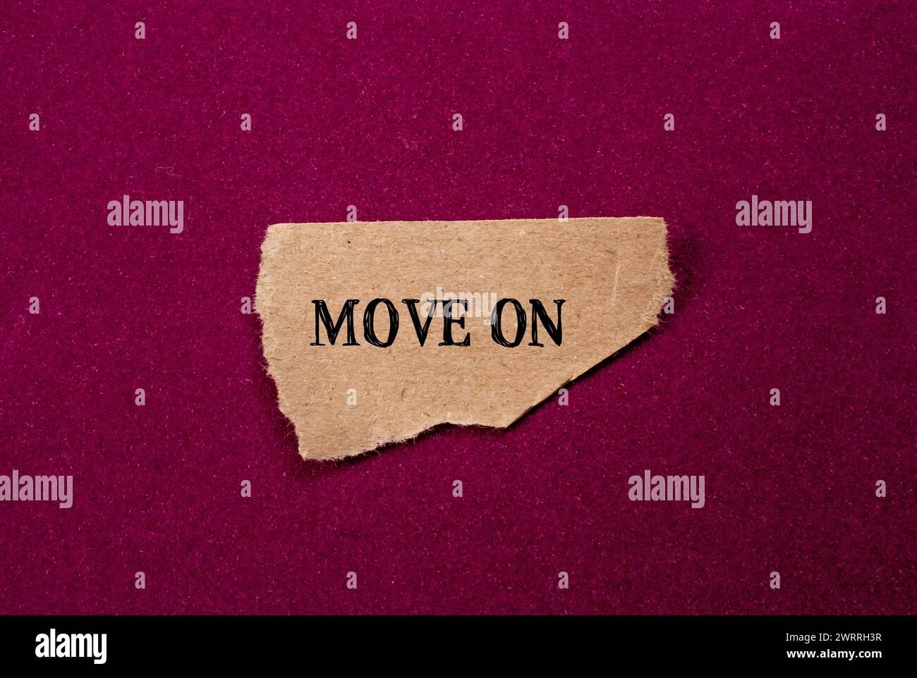 Move on words written on torn paper piece with purple background. Conceptual symbol. Copy space ...