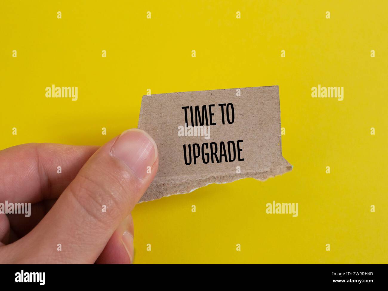 Time to upgrade words written on torn paper piece with yellow ...