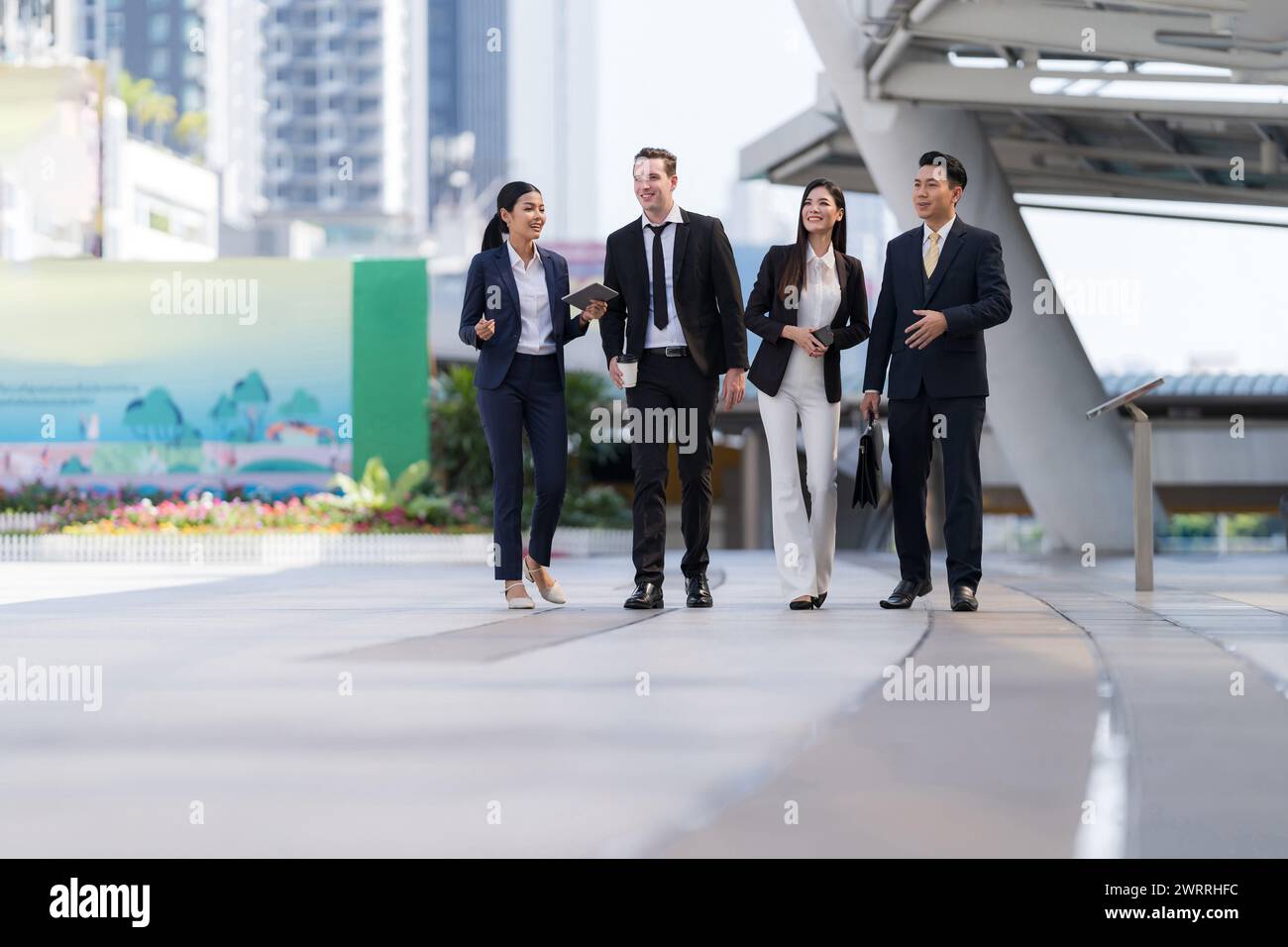 Business partners walking outside talking hi-res stock photography and ...