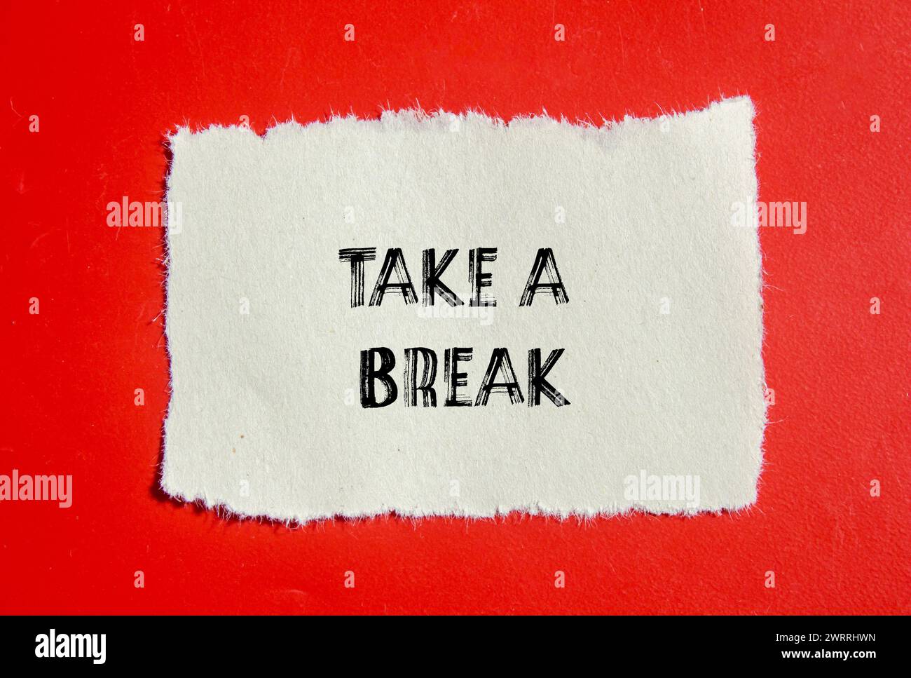 Take a break words written on torn paper piece with red background ...