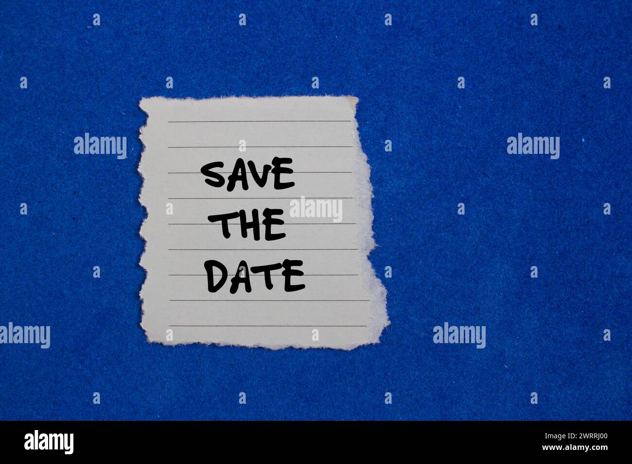 Save the date words written on torn paper with blue background ...