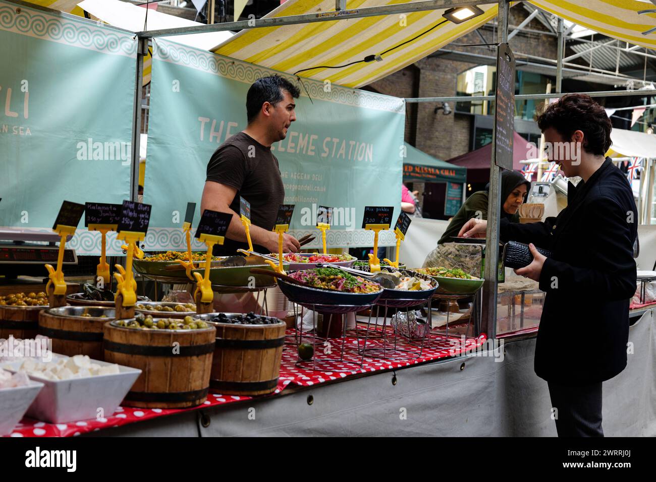 London - 06 03 2022: Fresh produce stall with customer in Canopy market ...