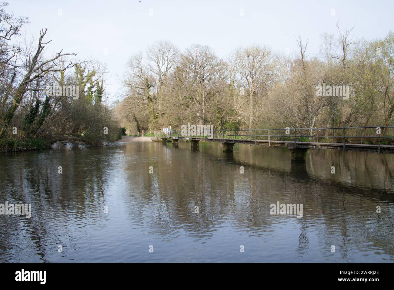 The Frome River and a bridge at Moreton Ford in Moreton, Dorset in the ...