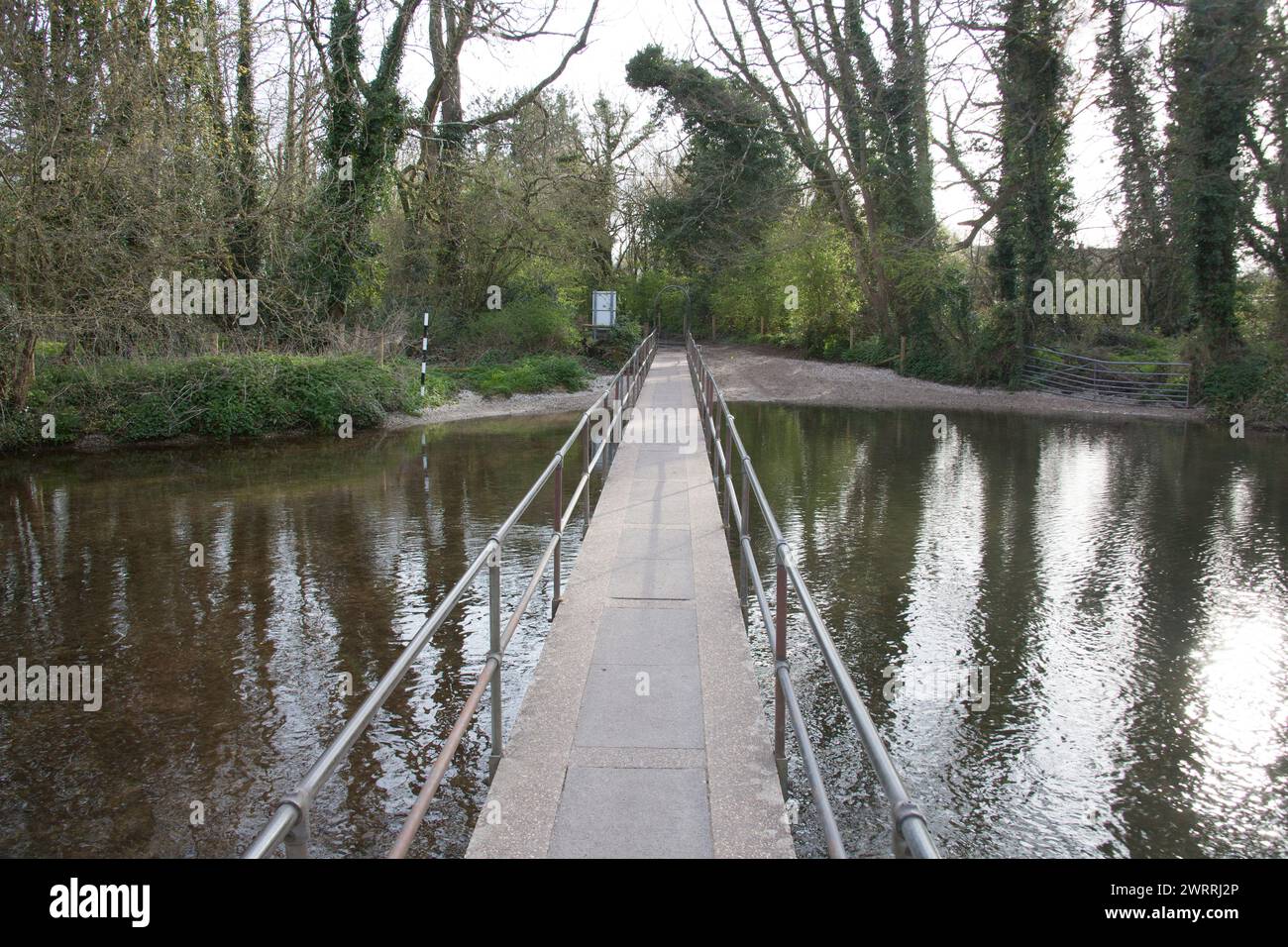 The Frome River and a bridge at Moreton Ford in Moreton, Dorset in the ...