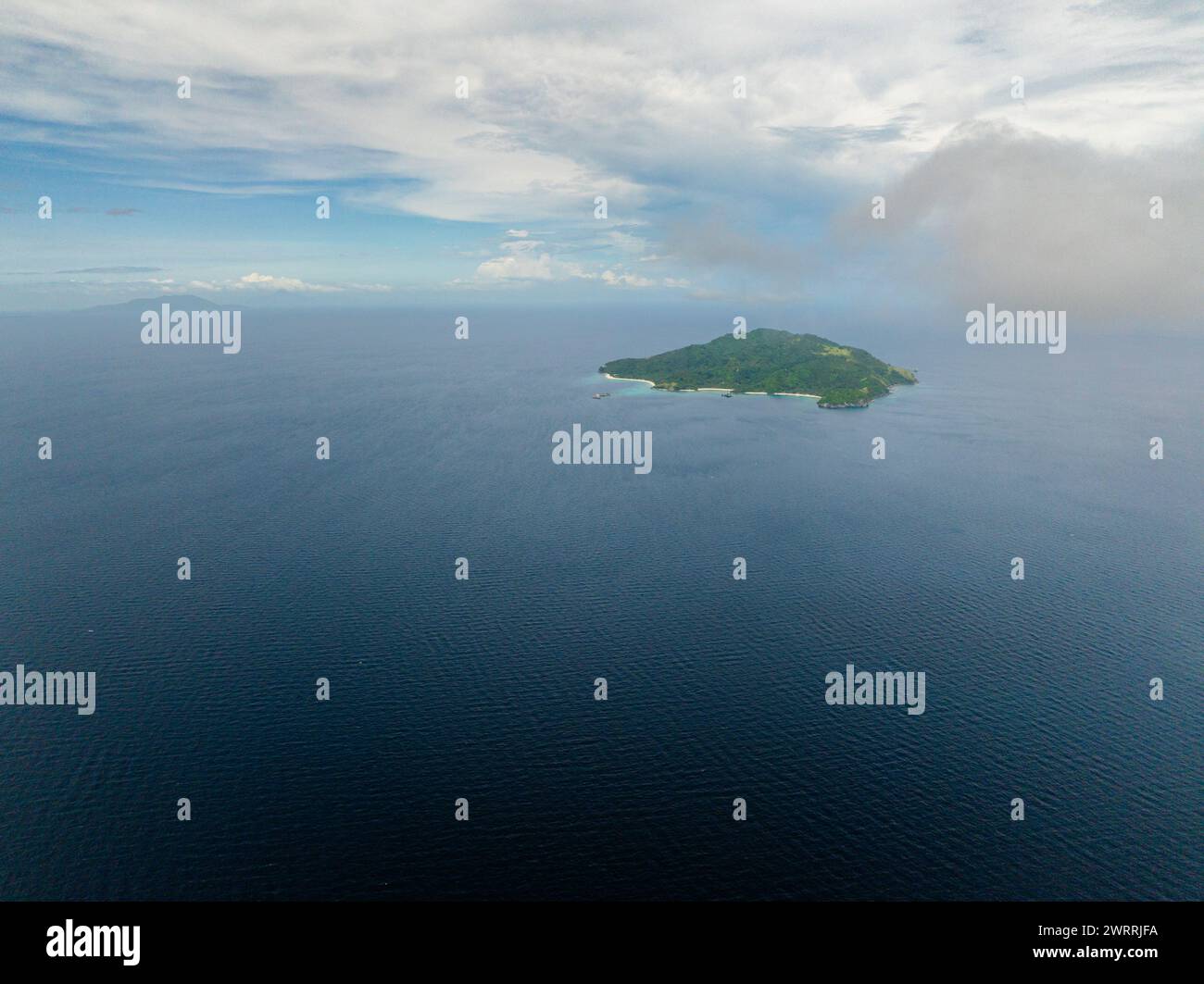 Aerial view of Cobrador Island surrounded by deep blue sea in Romblon ...