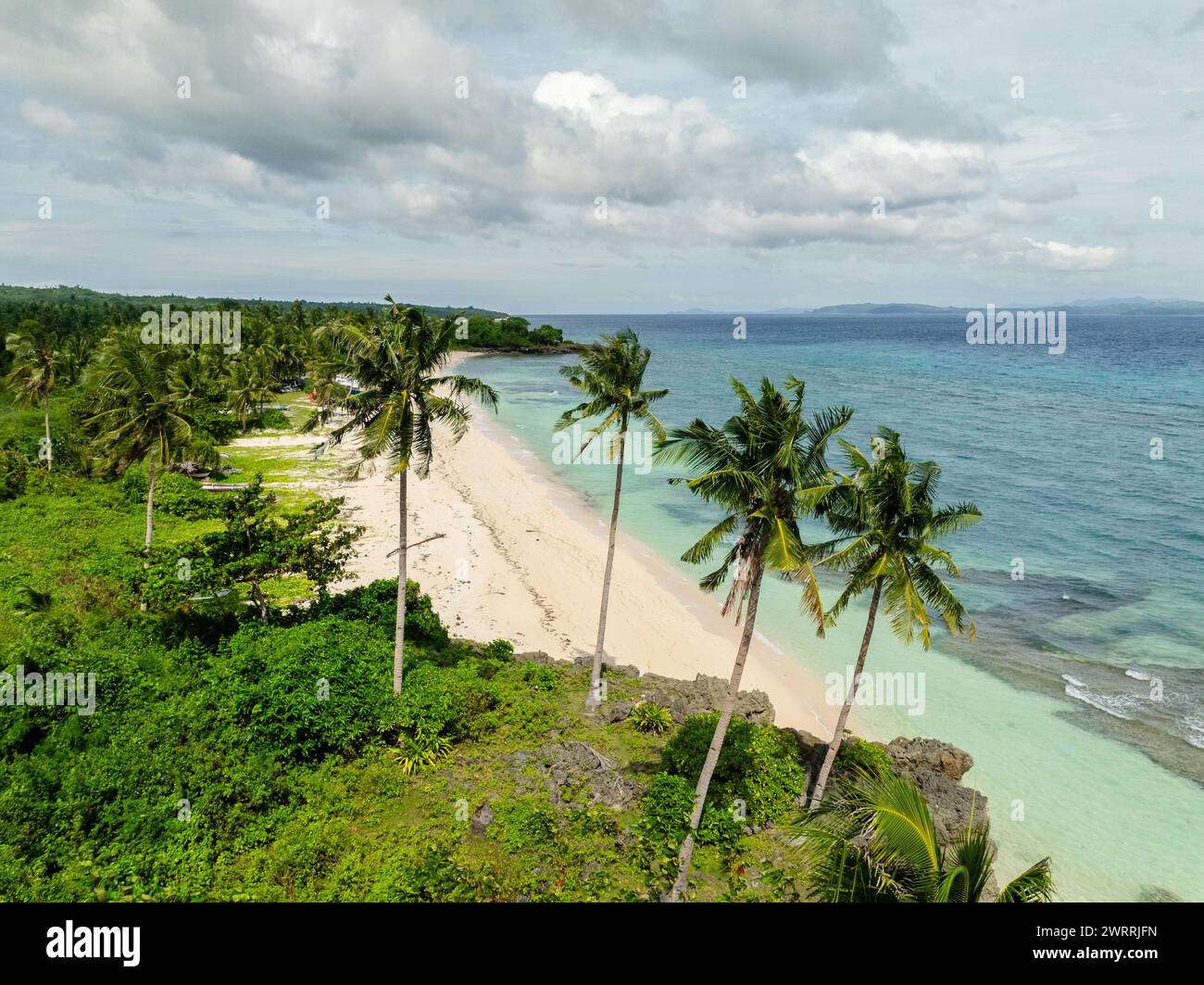 Tropical landscape with beach and clear turquoise sea water with corals ...