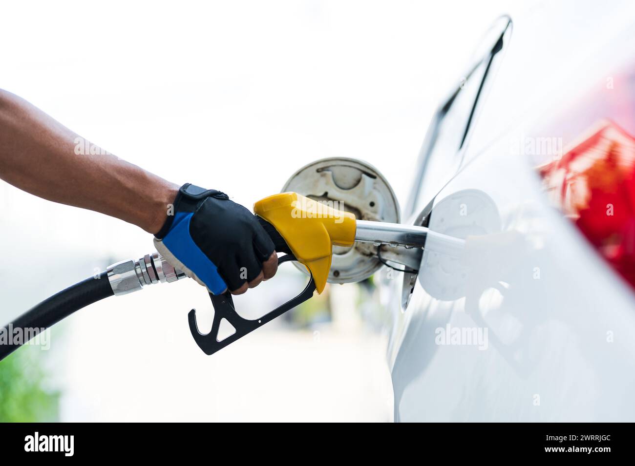Man hand filling and pumping gasoline oil the car with fuel at station ...