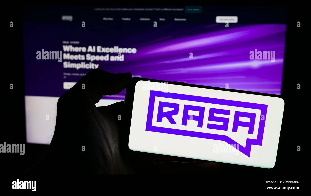 Person holding mobile phone with logo of American conversational AI company Rasa Technologies ...