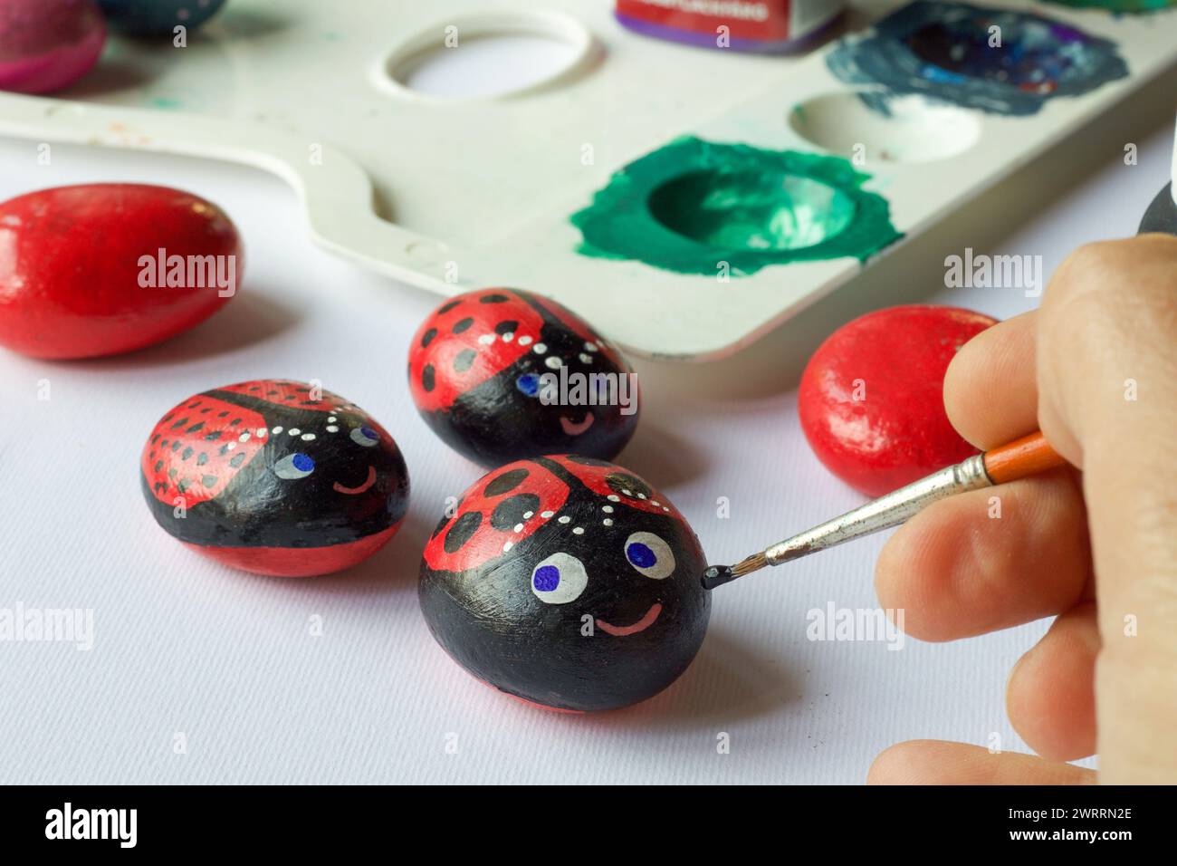 homemade painted stones as ladybugs, creative hobby Stock Photo - Alamy