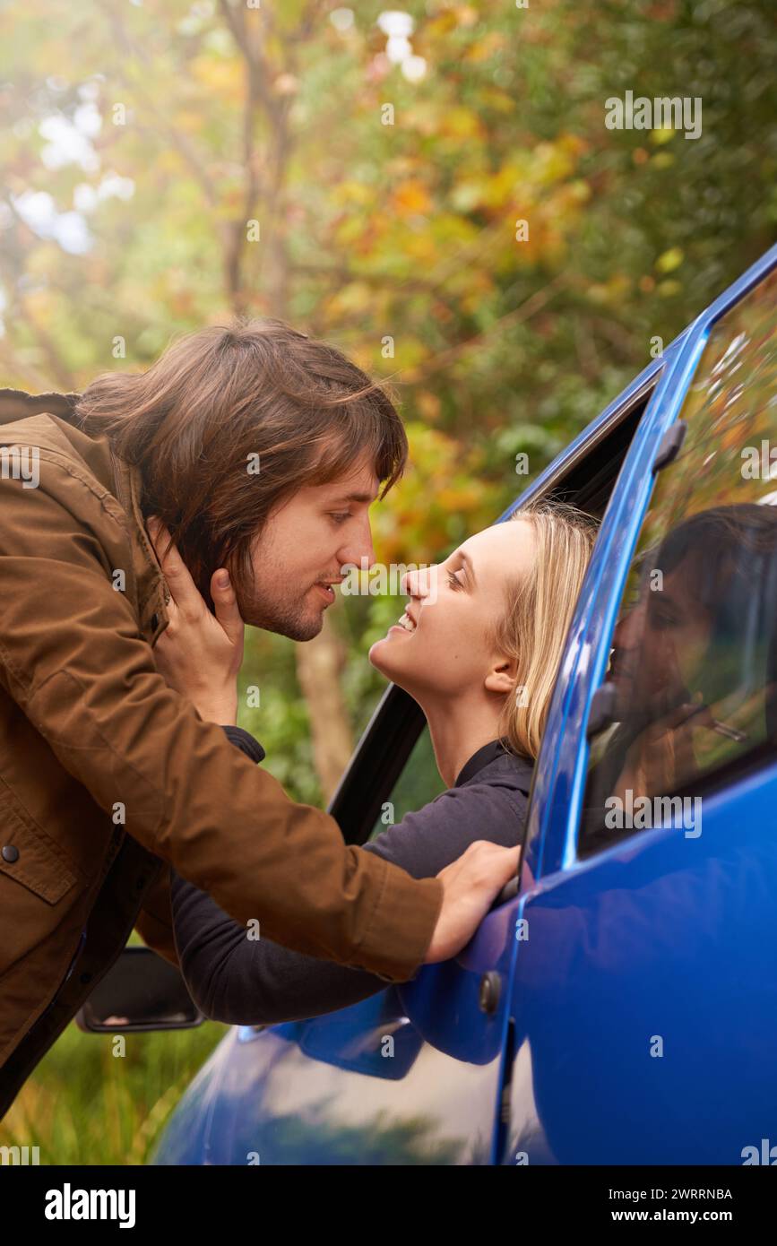 Travel, window and couple kiss in car for greeting, goodbye and love on ...