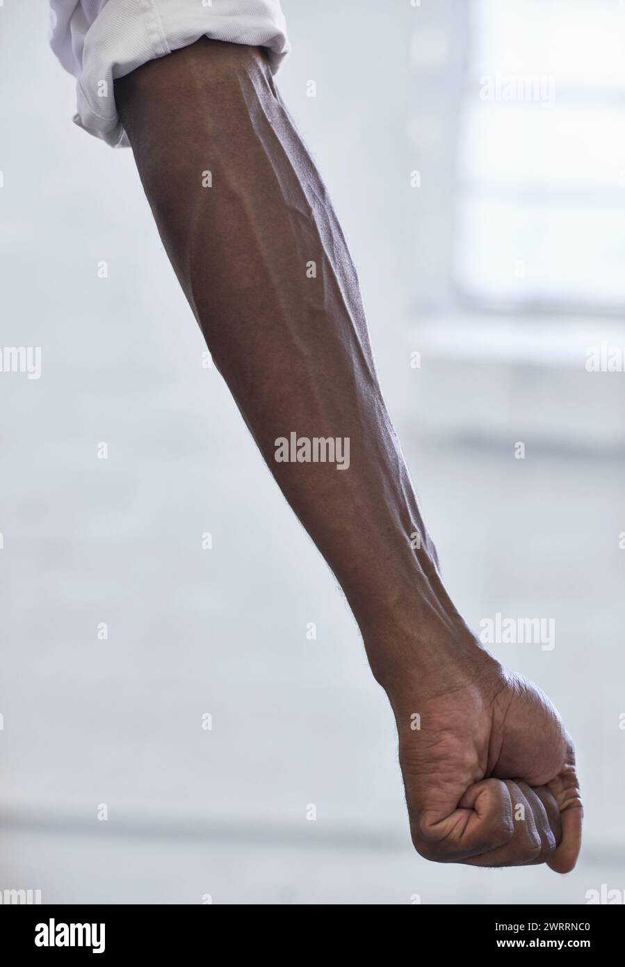 Strong, person and vein from muscle in arm with fist for power in white ...