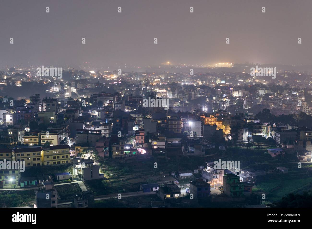 Aerial night Kathmandu cityscape with lot of low rise buildings with ...