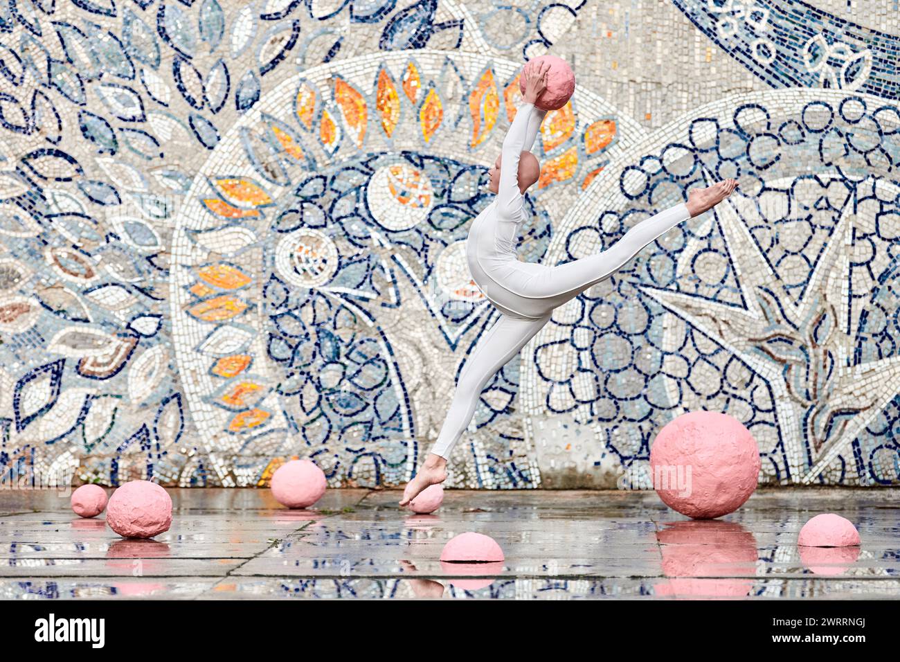 Young hairless girl ballerina with alopecia in white futuristic suit ...