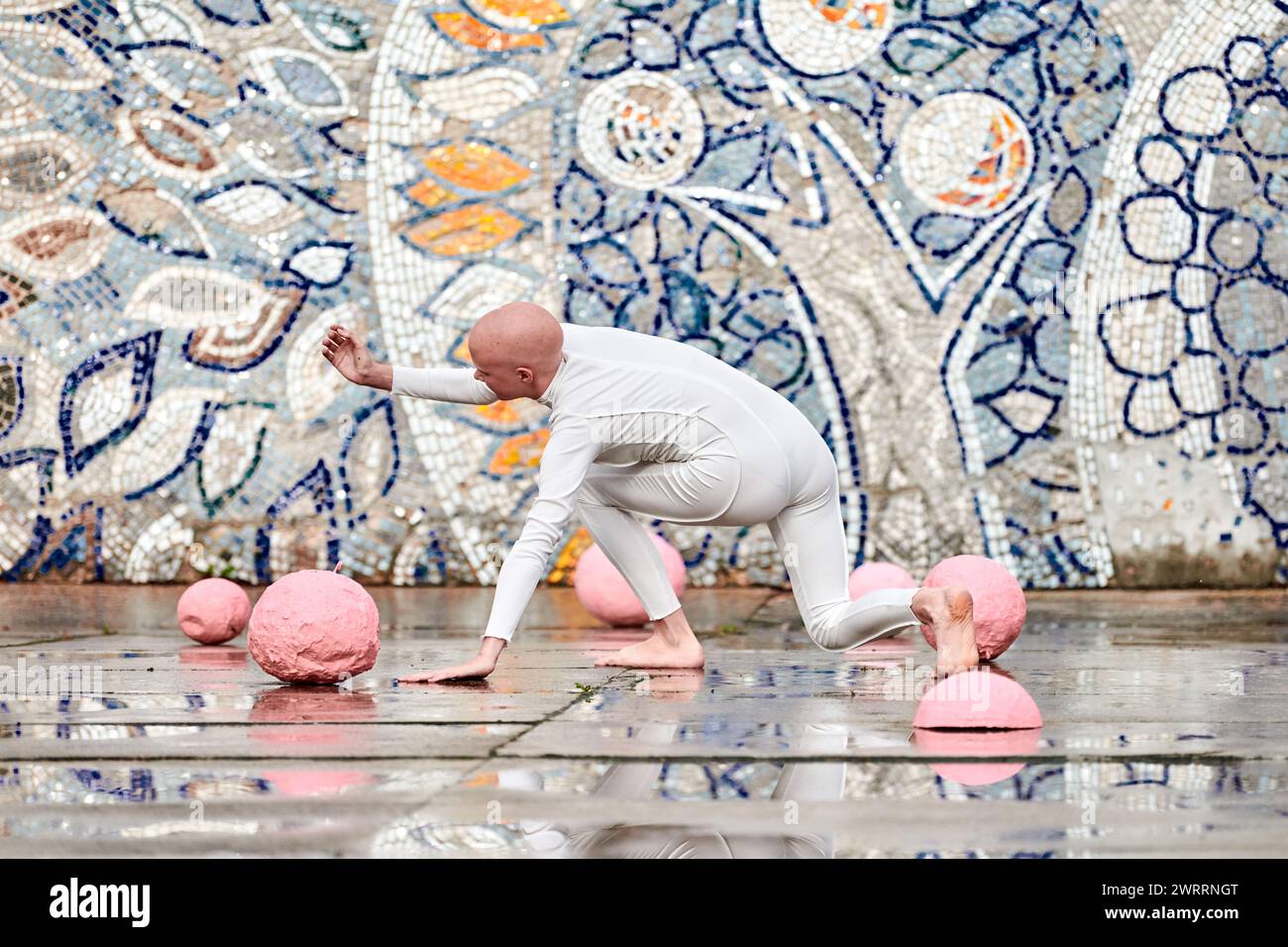 Outdoor dance of young ballerina girl with alopecia in white futuristic ...
