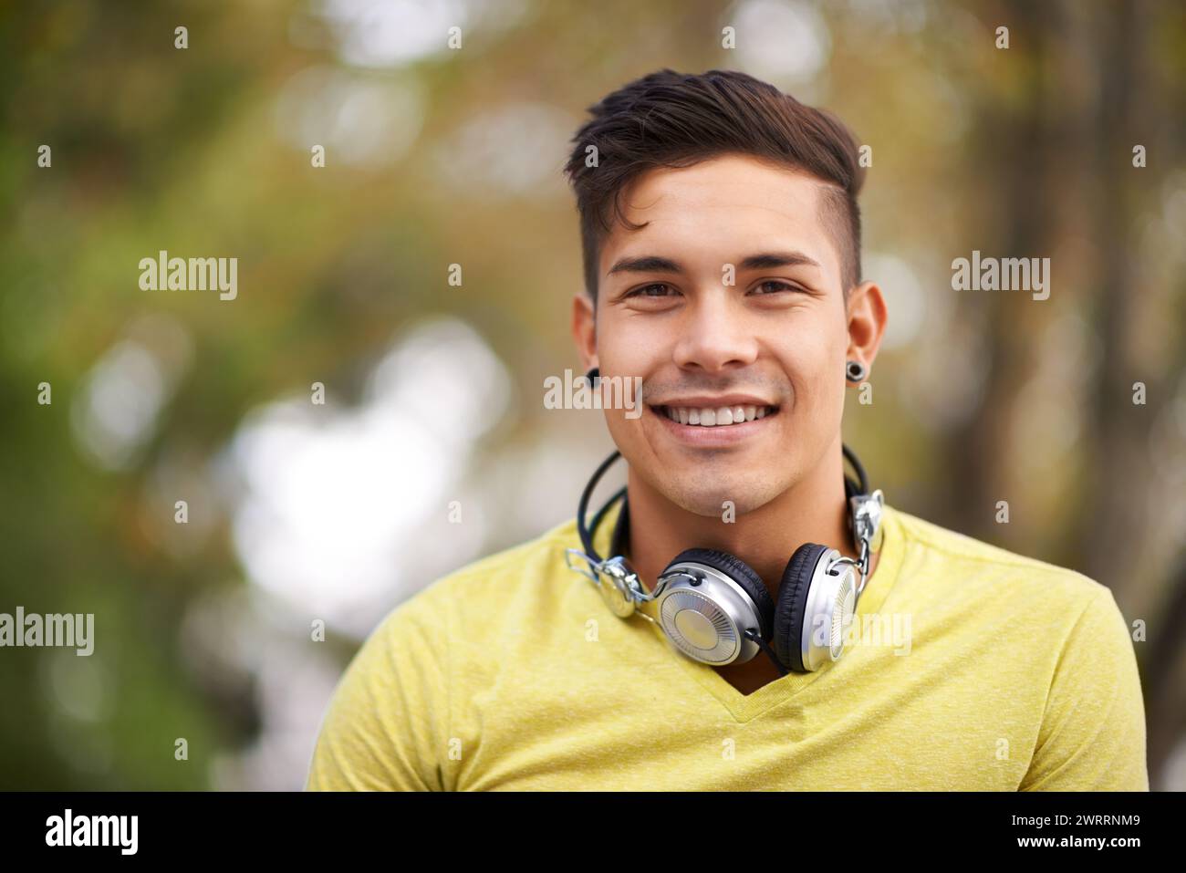 Smile, portrait and young man in nature by outdoor park, field or ...