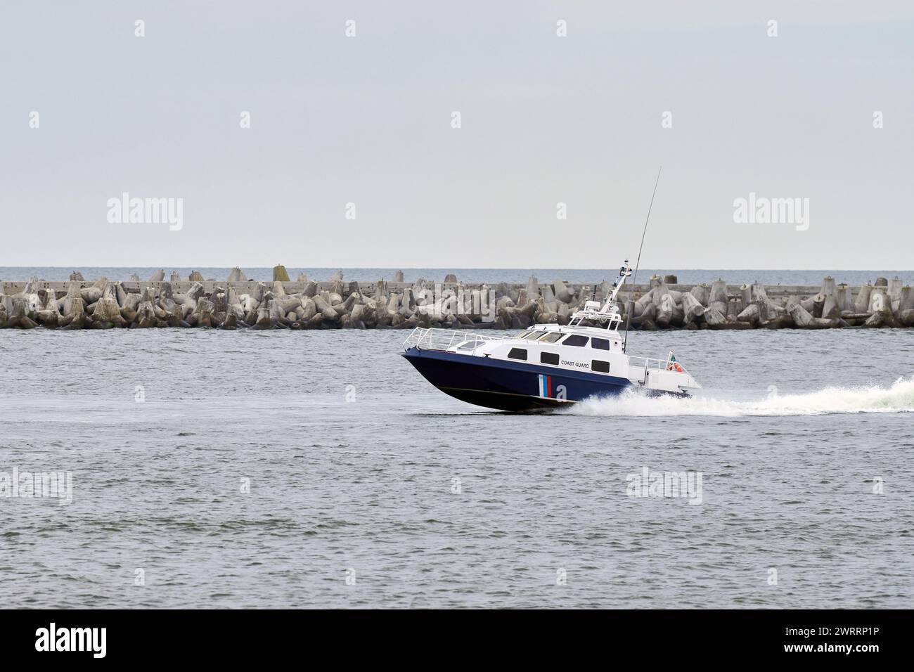 Coast guard boat sails along seaside for safeguarding coastal ...