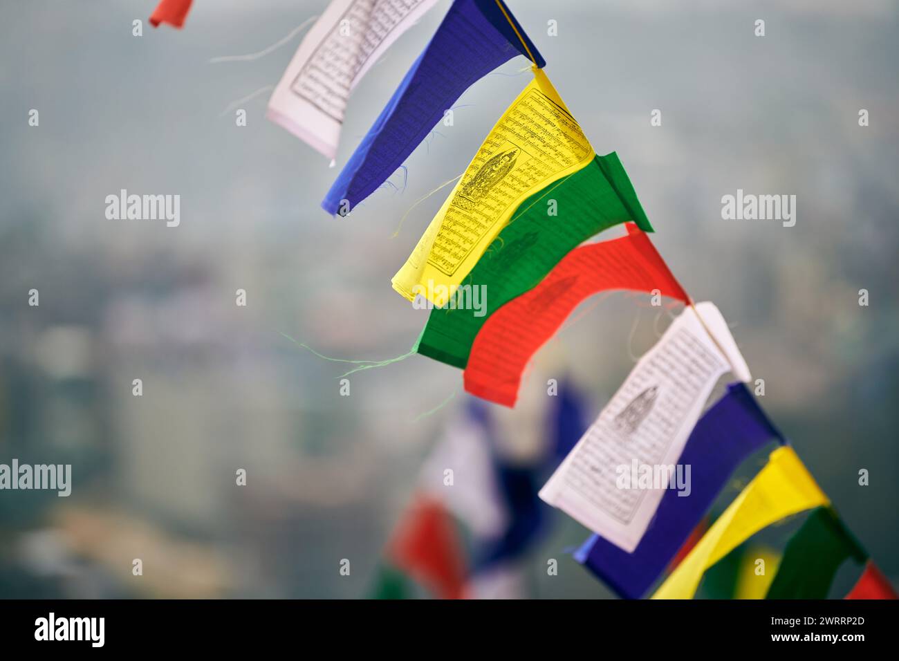 Colorful Tibetan prayer flags on blurred Kathmandu cityscape background ...