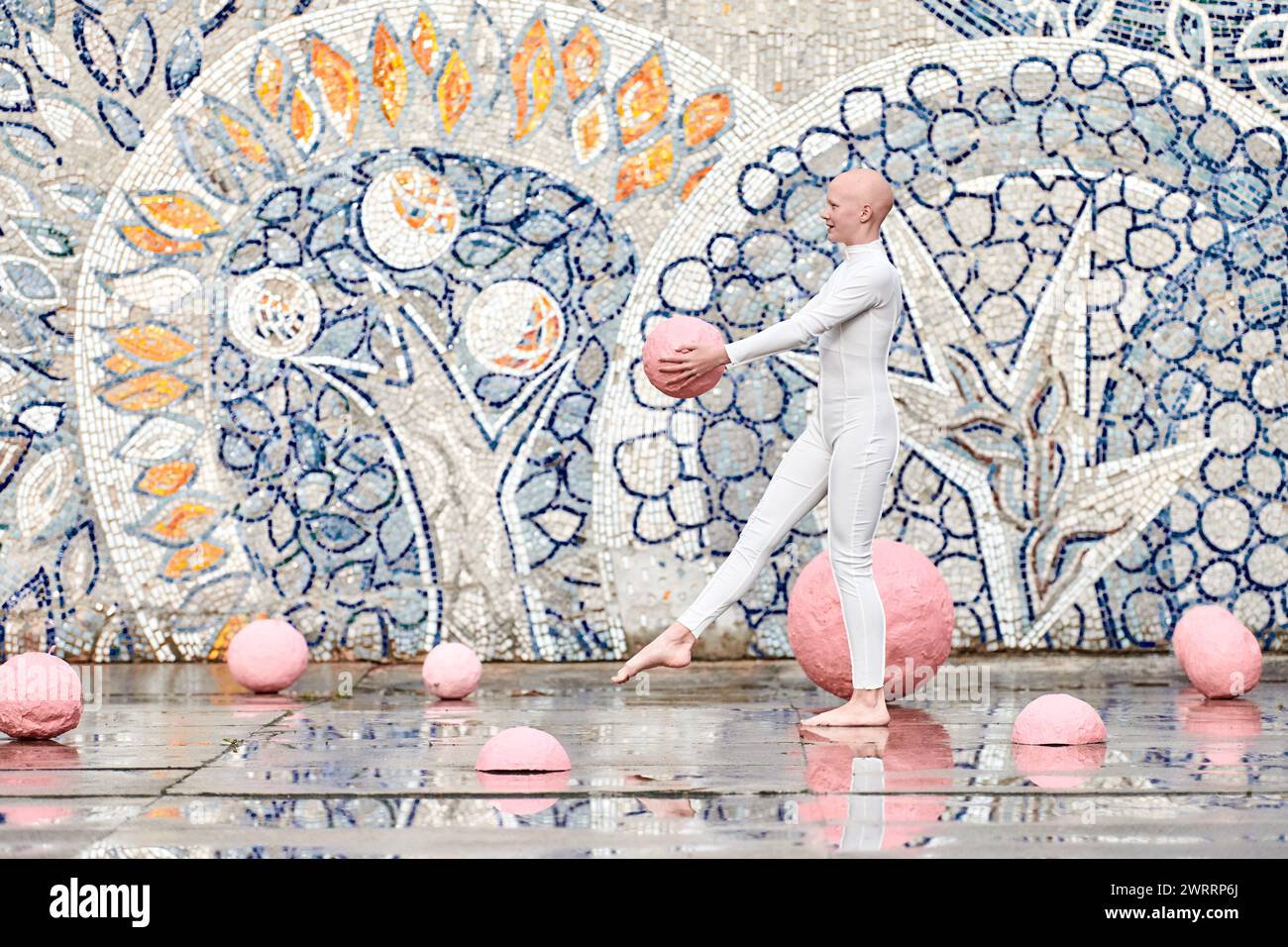 Young hairless girl ballerina with alopecia in white futuristic suit ...