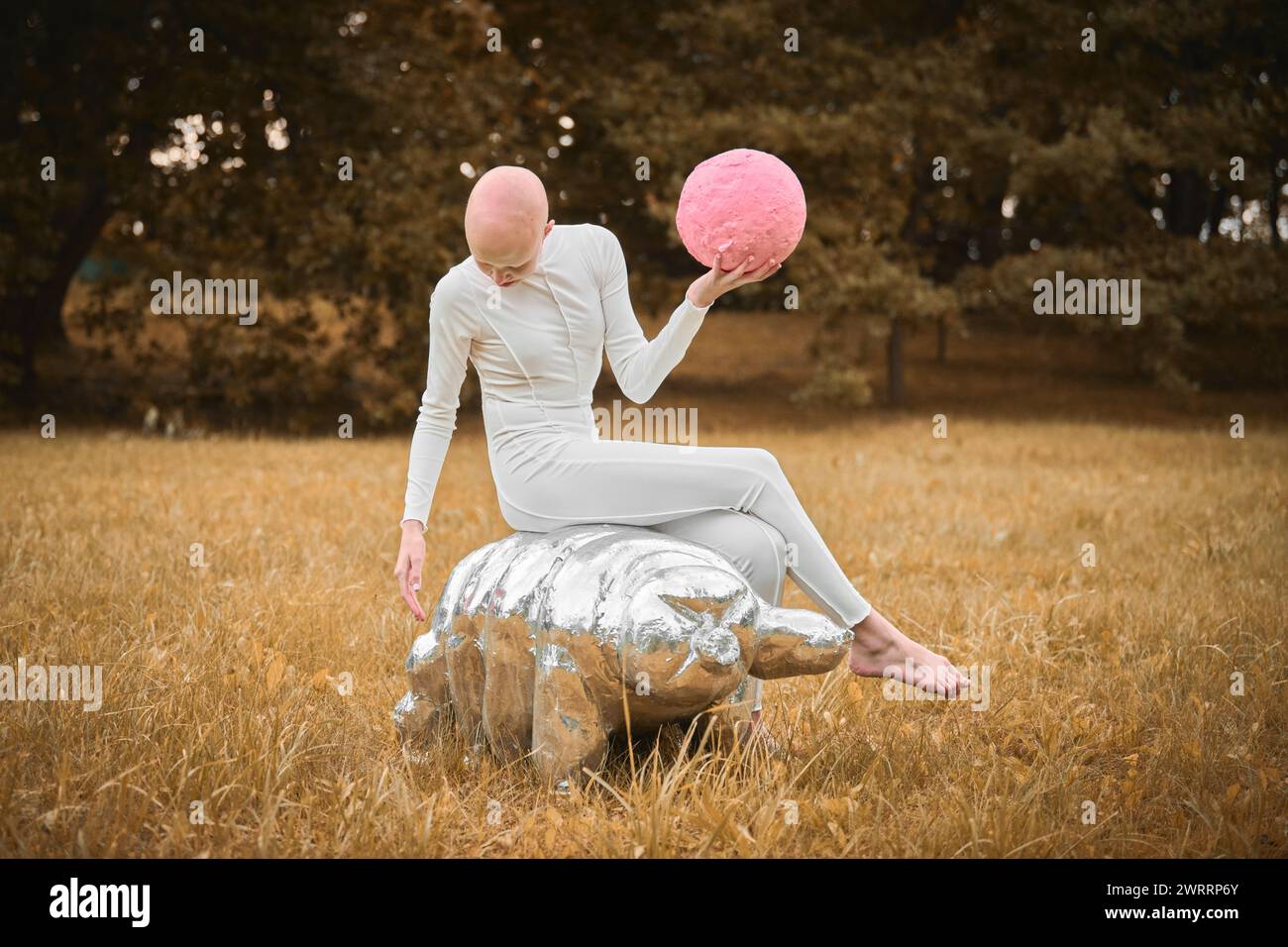 Young hairless girl with alopecia in white cloth sits on tardigrade ...