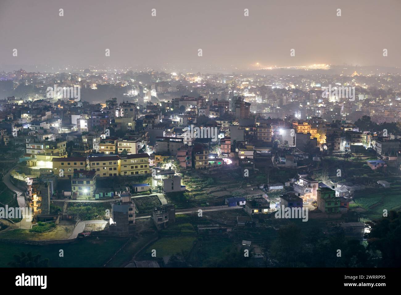 Aerial night Kathmandu cityscape with lot of low rise buildings with ...