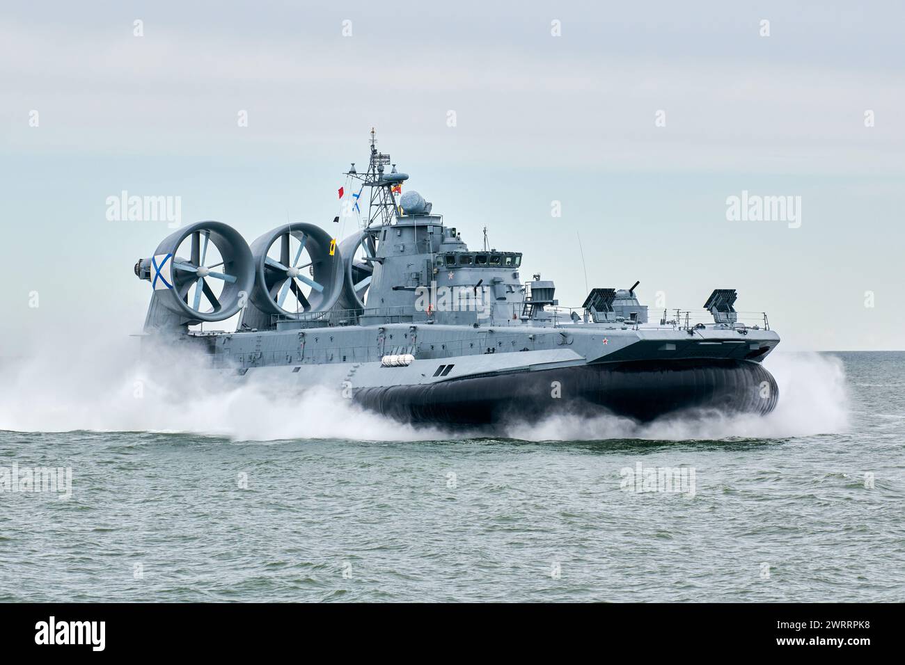 Hovercraft warship armed with armament sails into sea toward military target to attack and ...