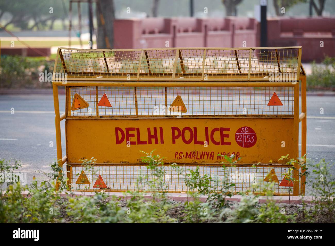 Yellow Delhi police road barrier among road blocking way for people and ...