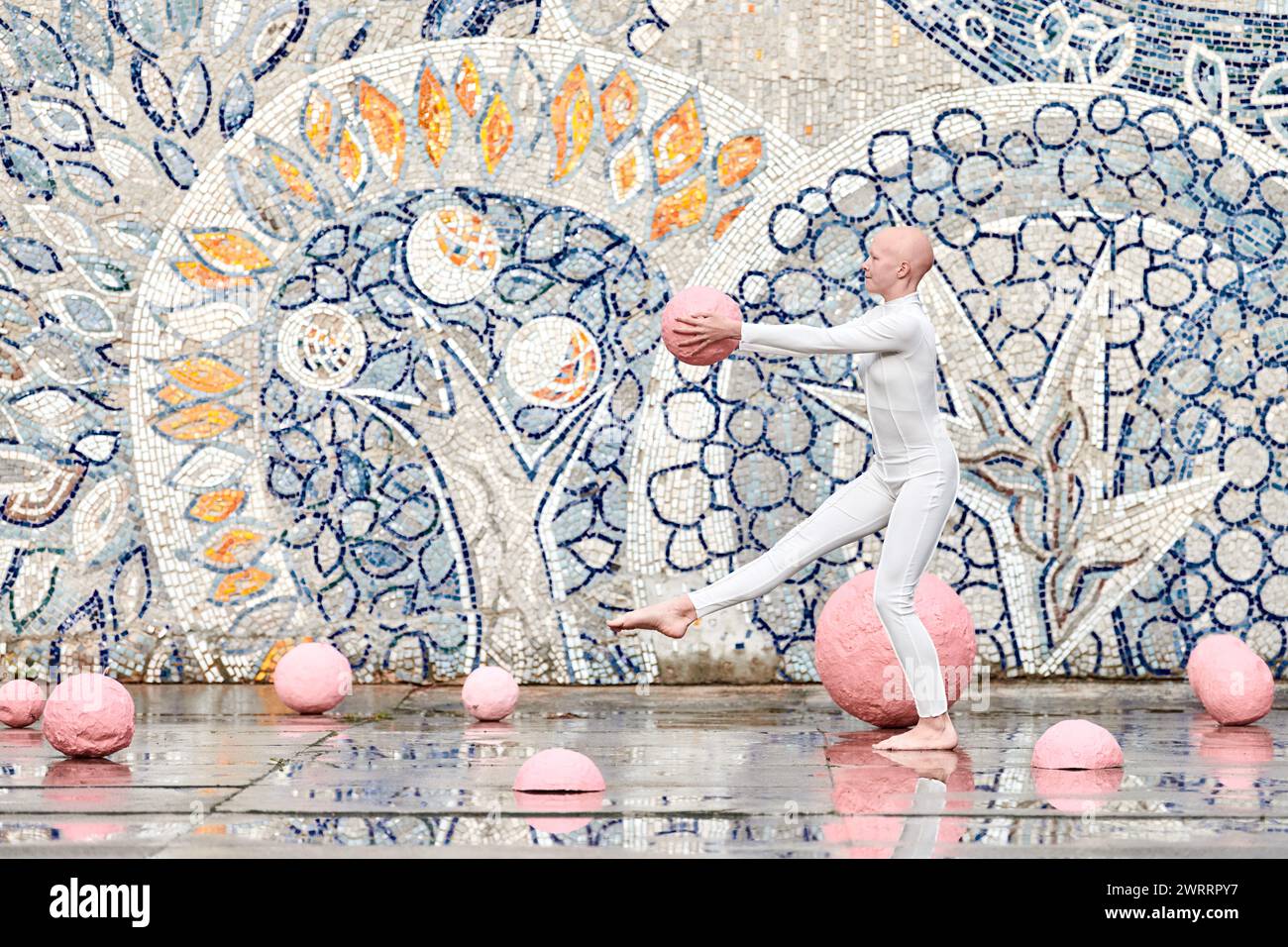 Young hairless girl ballerina with alopecia in white futuristic suit ...