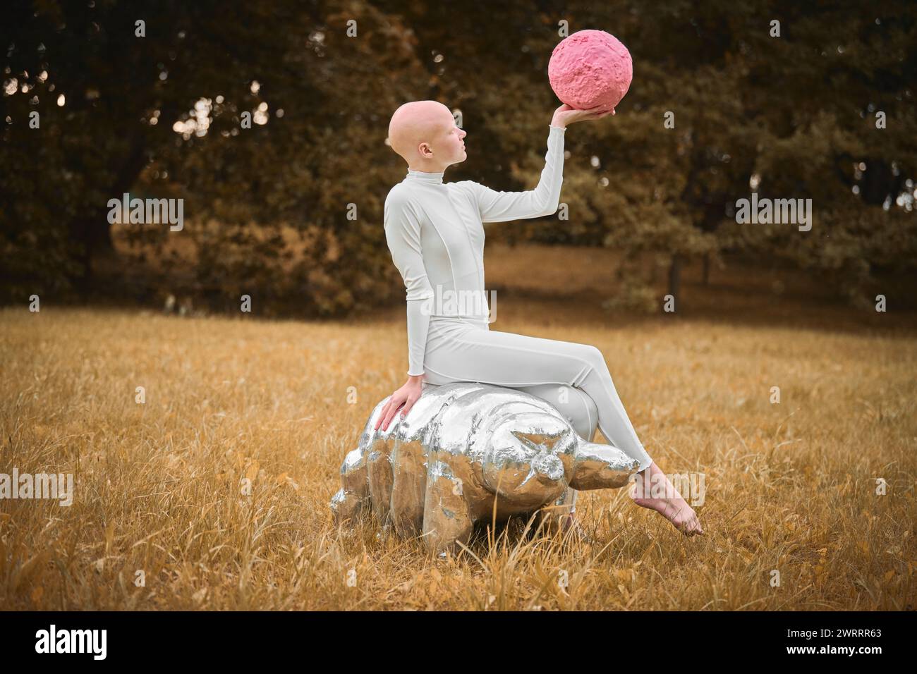 Young hairless girl with alopecia in white cloth sits on tardigrade ...