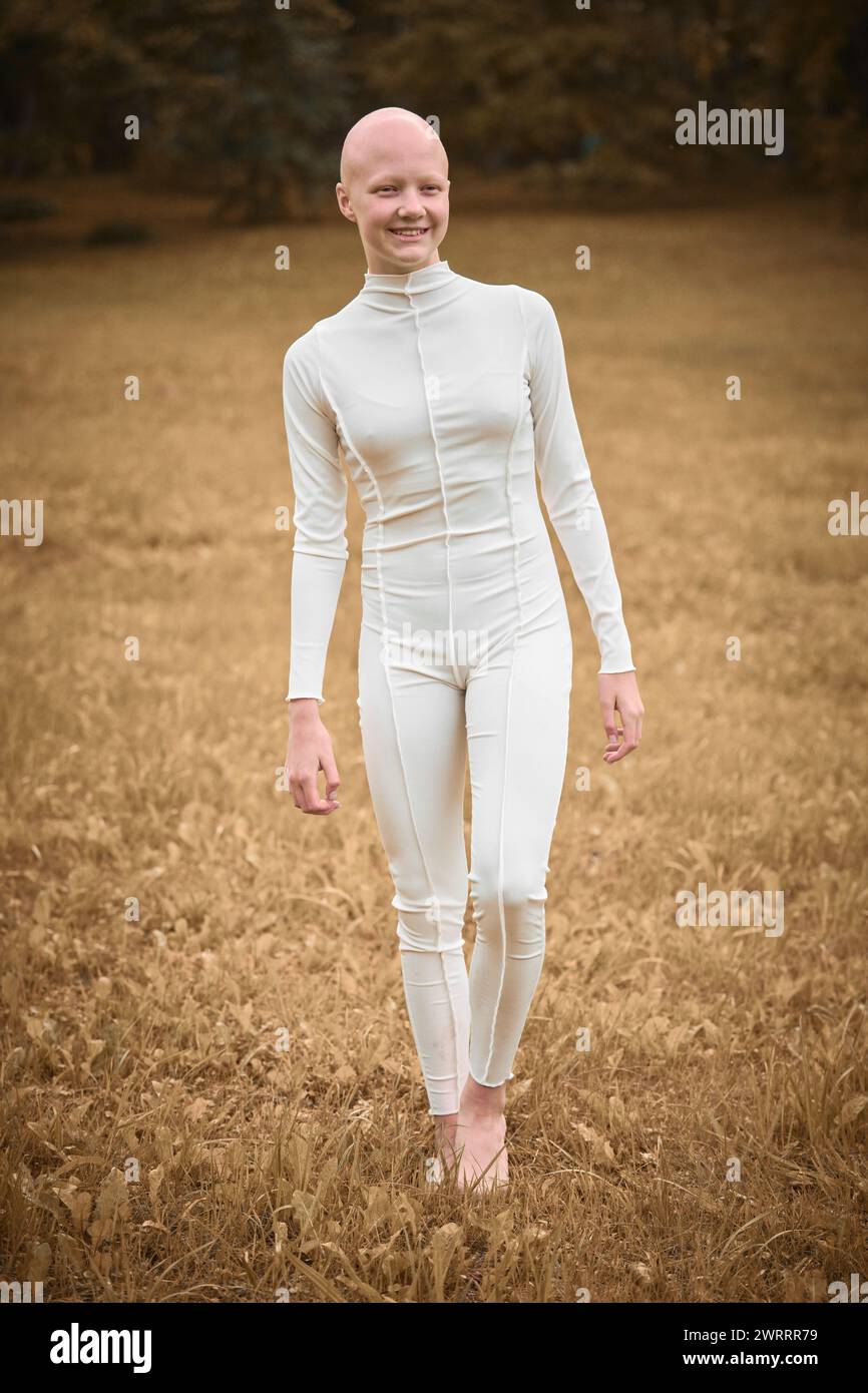 Full length portrait of young hairless girl with alopecia in white ...