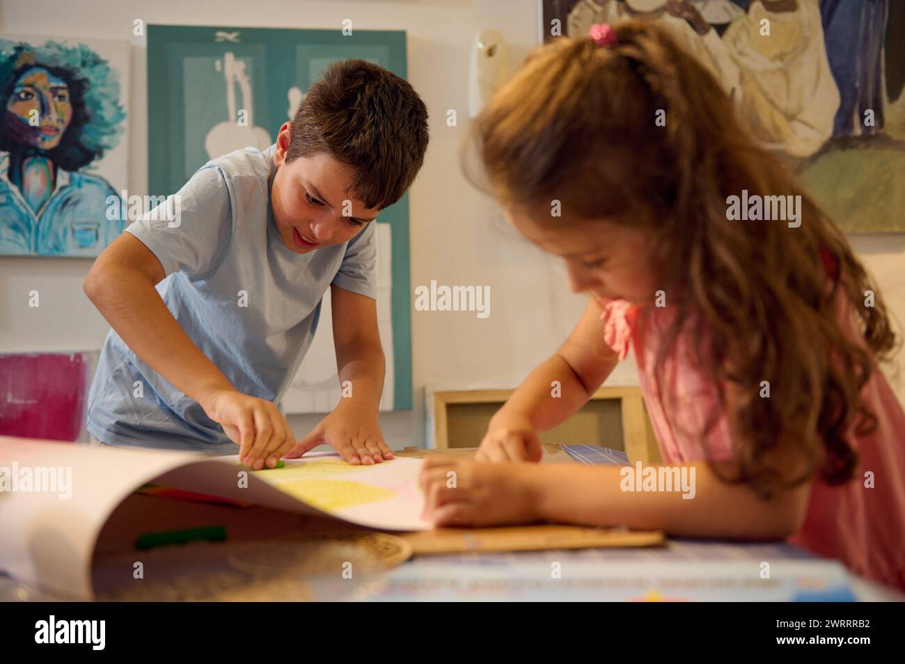 Two children, elementary age schoolkids drawing picture during art ...