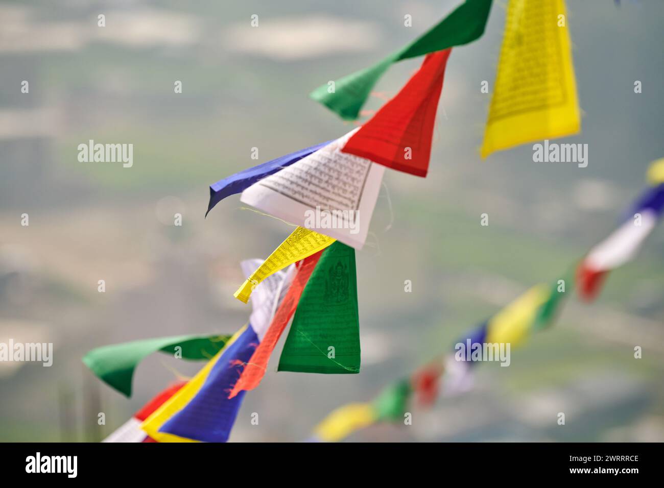 Colorful Tibetan prayer flags on blurred Kathmandu cityscape background ...