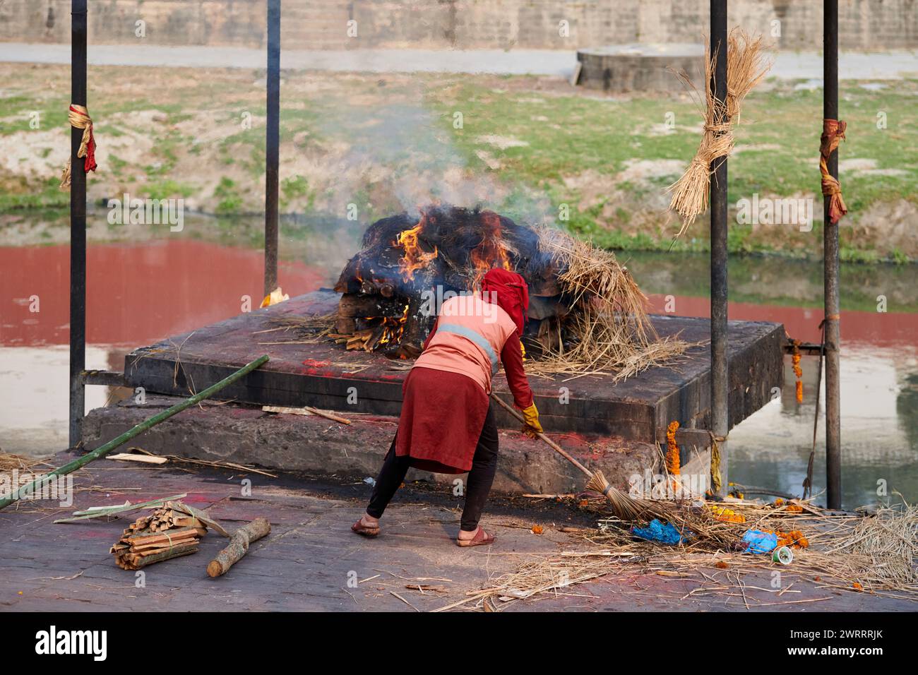 Staff employee of Pashupatinath Temple complex overseeing for funeral ...
